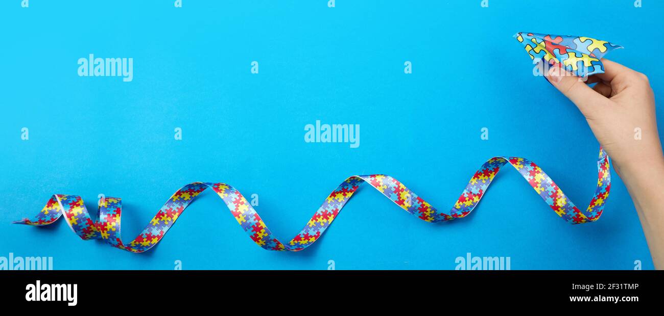 Autism awareness. Aitistic child hand holding paper plane in origami ...