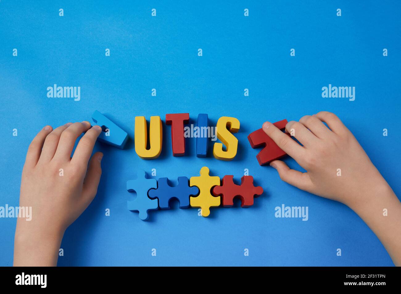 Autistic kid hands holding puzzle jigsaw and word autism, mental health ...