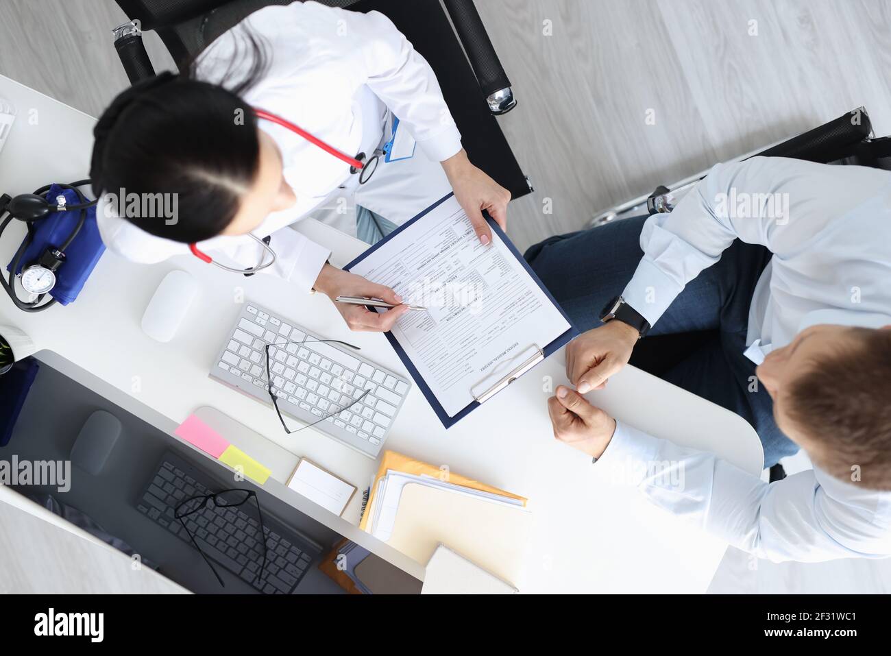 Doctor writes patient medical data into card Stock Photo - Alamy