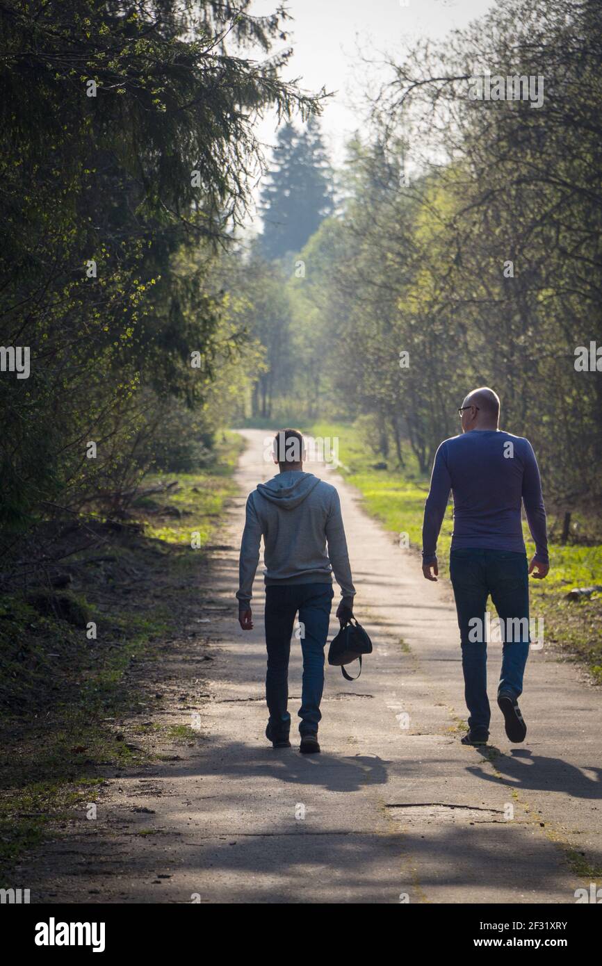 Two guys walking in park hi-res stock photography and images - Alamy