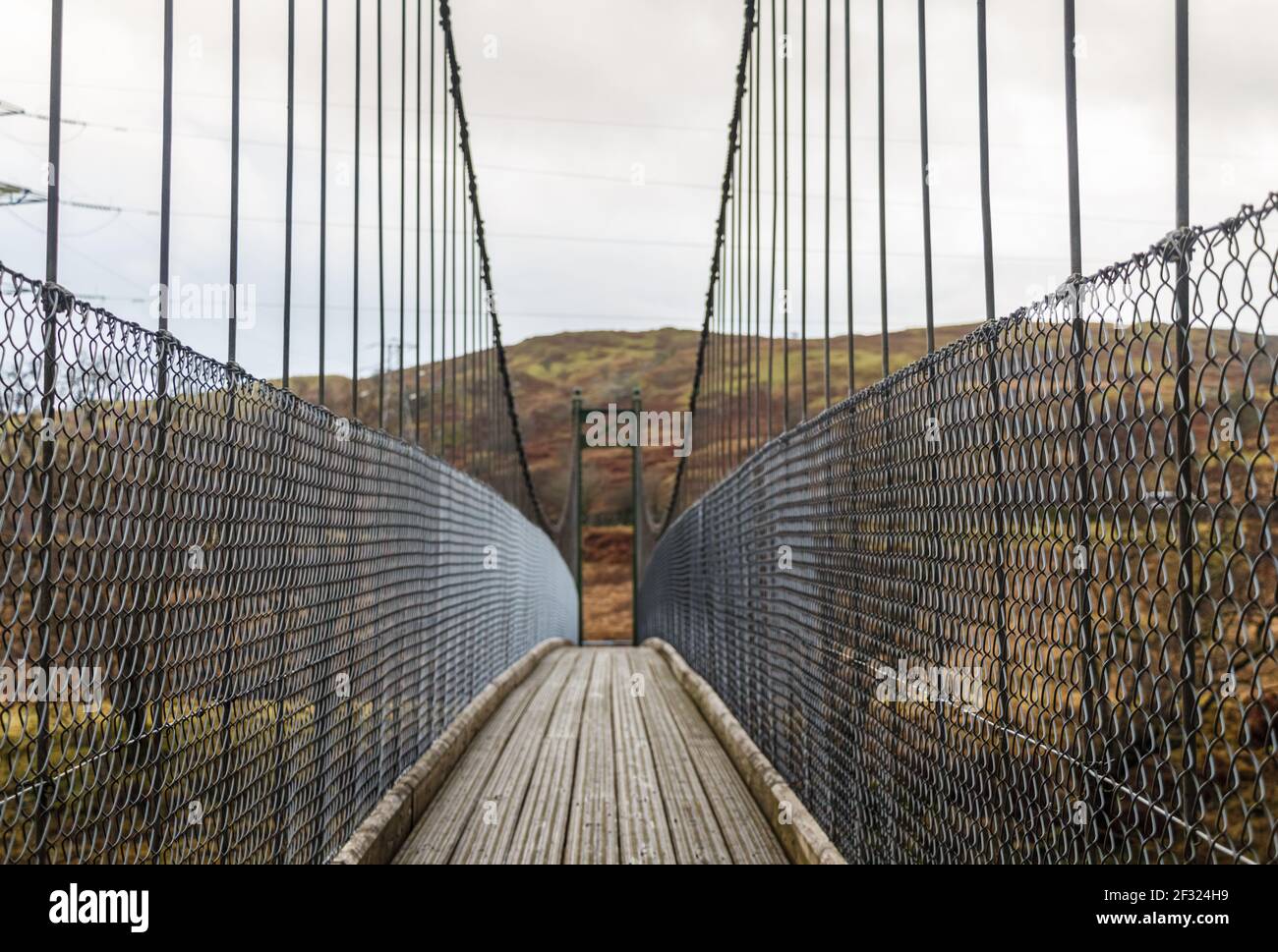 View across a wooden suspension bridge in the Scottish highlands near ...