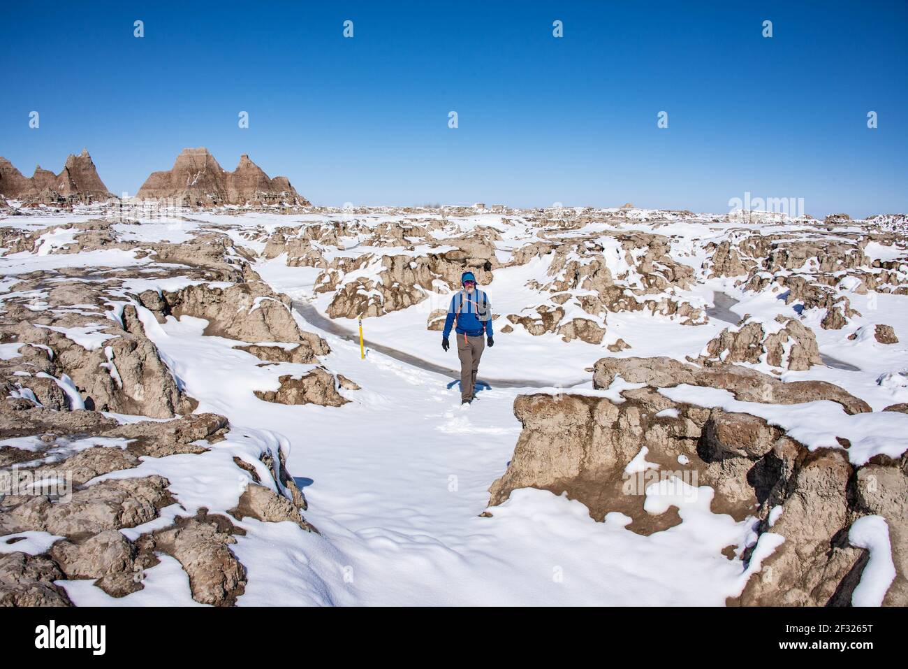 Trekking in Badlands National Park in winter, South Dakota, U. S. A ...