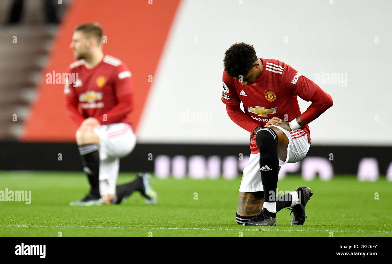 Manchester United's Marcus Rashford takes a knee prior to the Premier ...