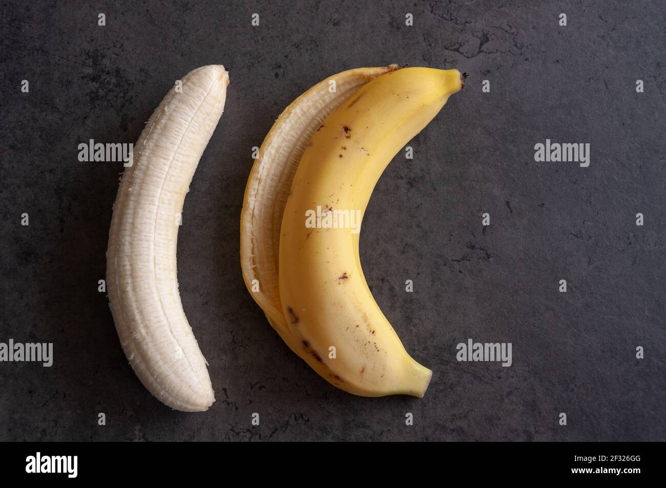 Healthy food. Ripe banana without peel on a grey background Stock Photo ...