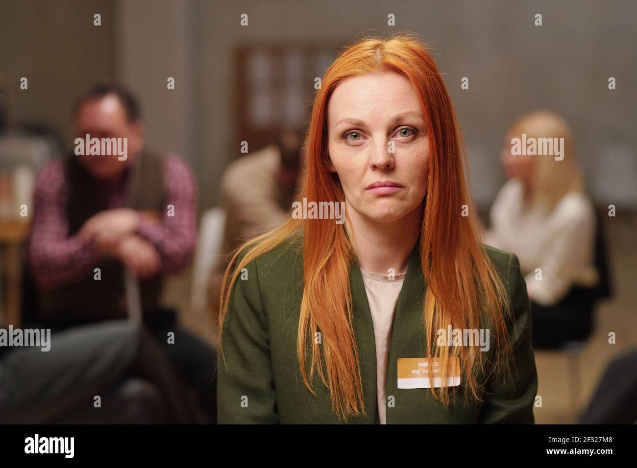 Serious middle aged woman in casualwear looking at you while sitting ...