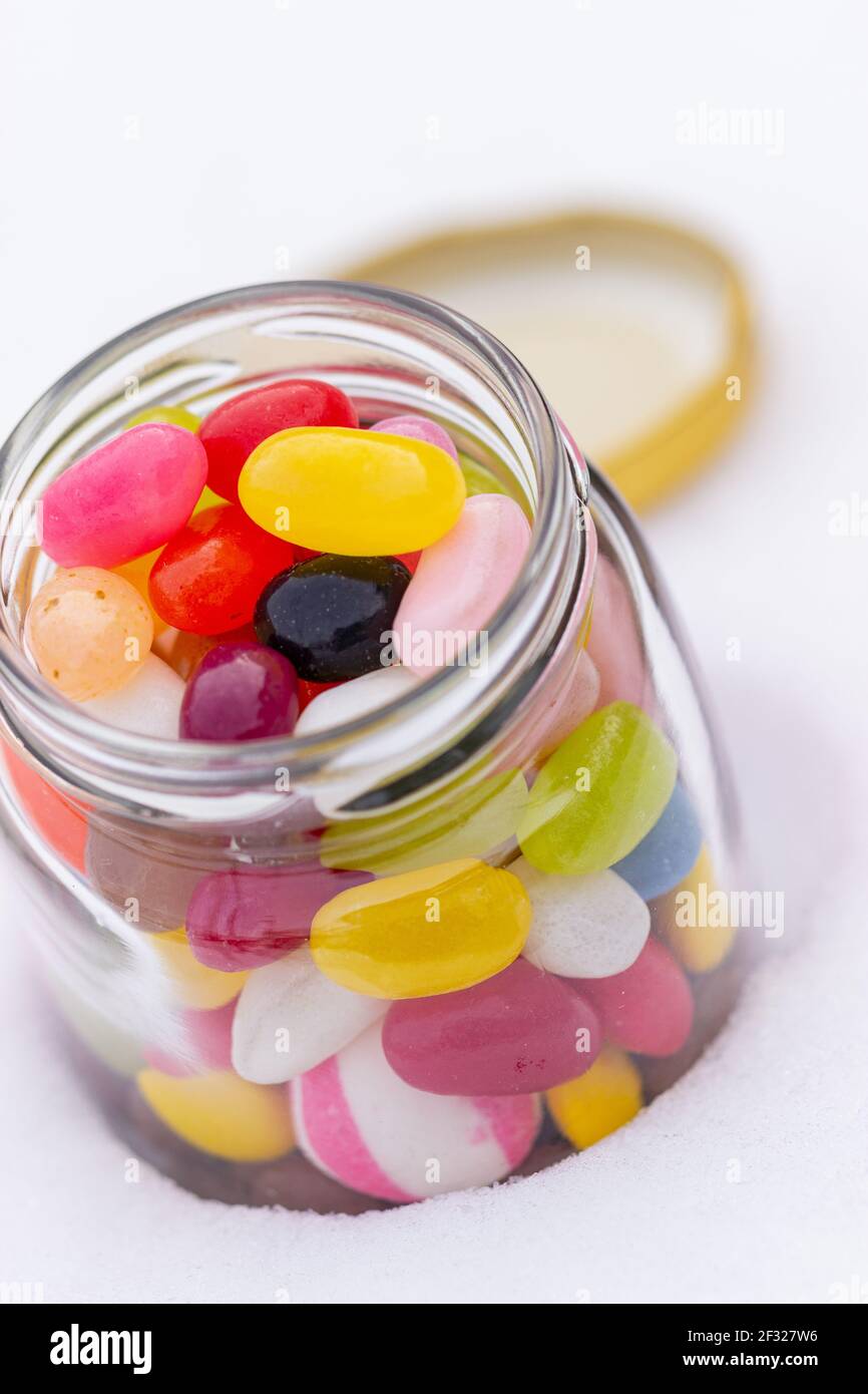 Colorful jelly beans in a jar isolated on white Stock Photo - Alamy