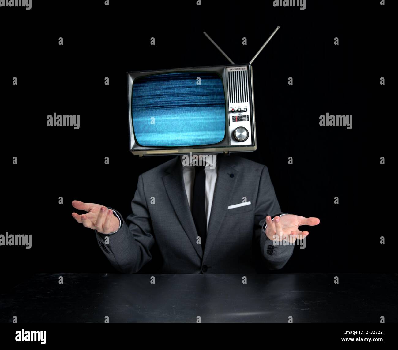 Man wearing suit with TV on head Stock Photo - Alamy