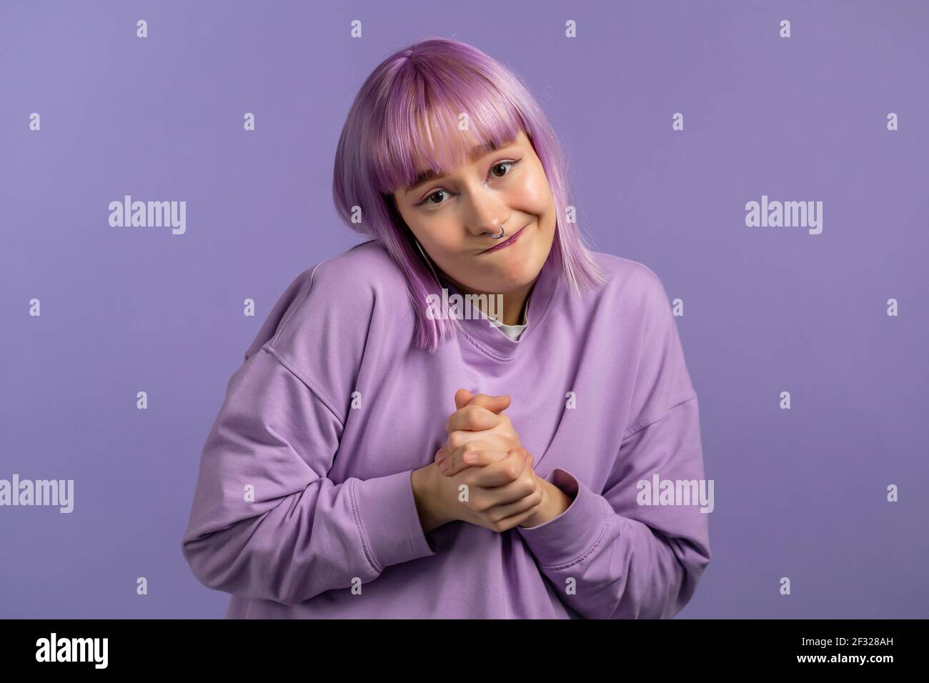 Guilty confused woman making oops, im sorry expression. Girl with dyed ...