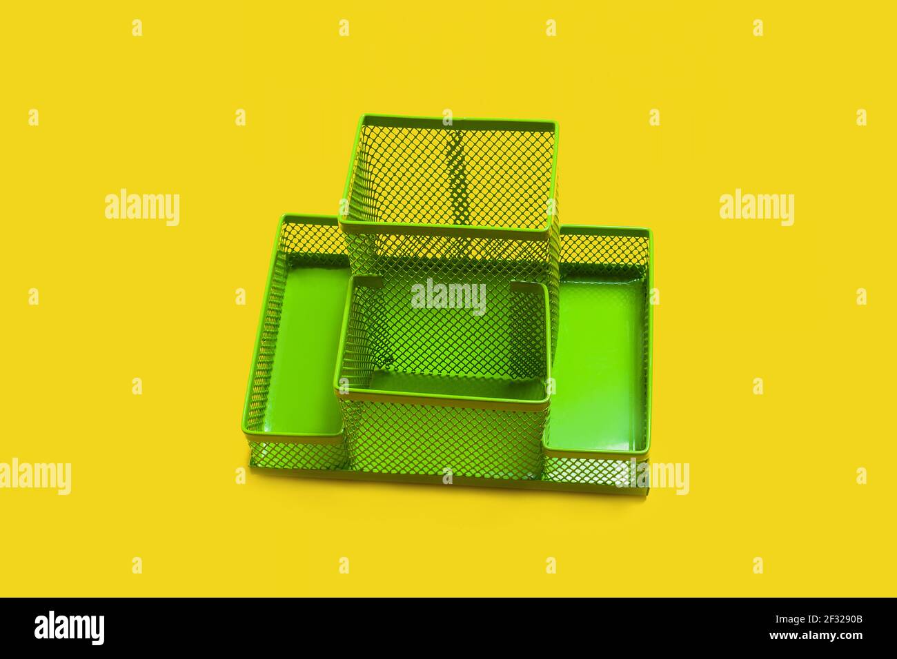 green empty pencil holder isolated on yellow background Stock Photo - Alamy