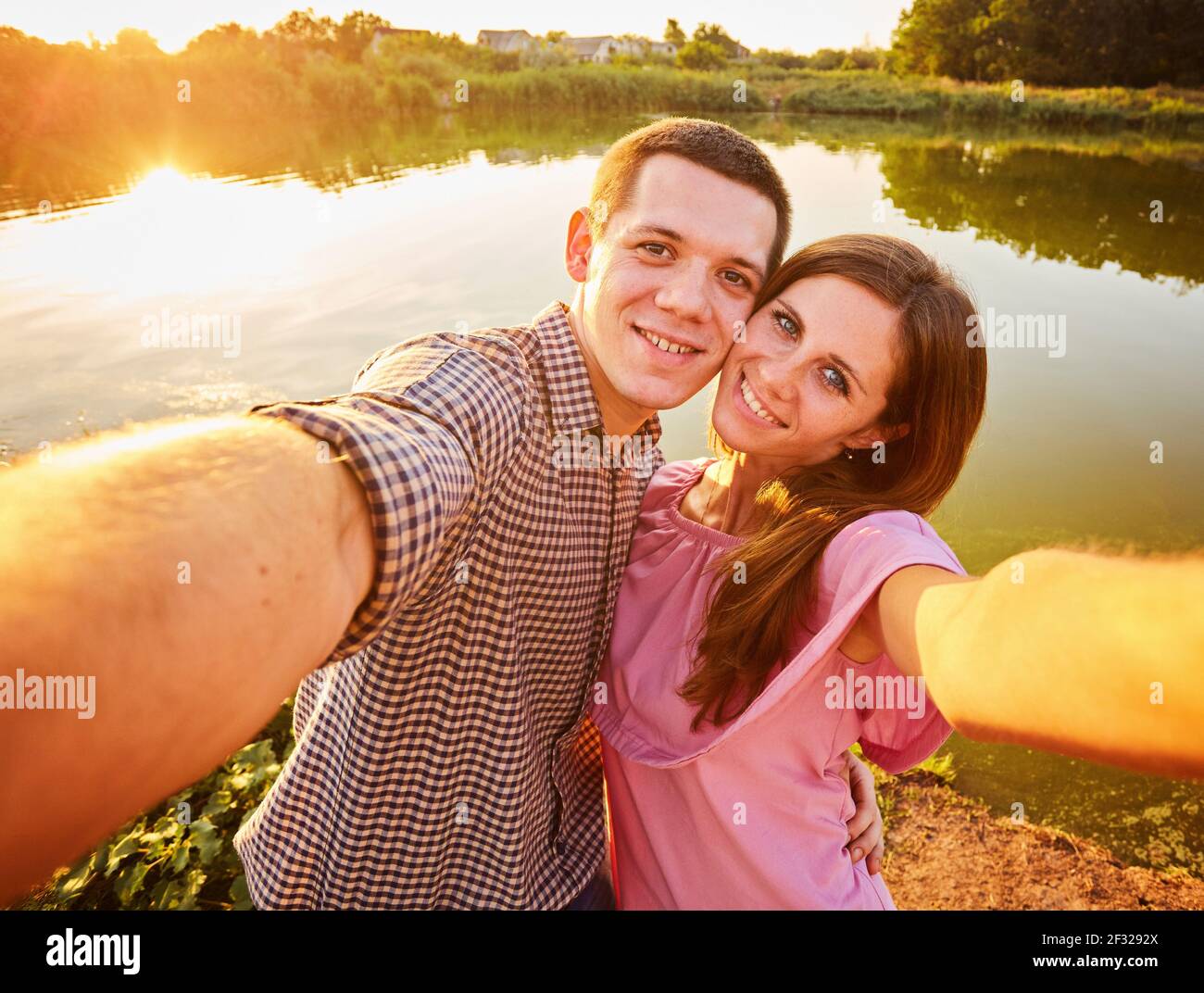 Portrait of Romantic couple embracing in love looking at camera ...