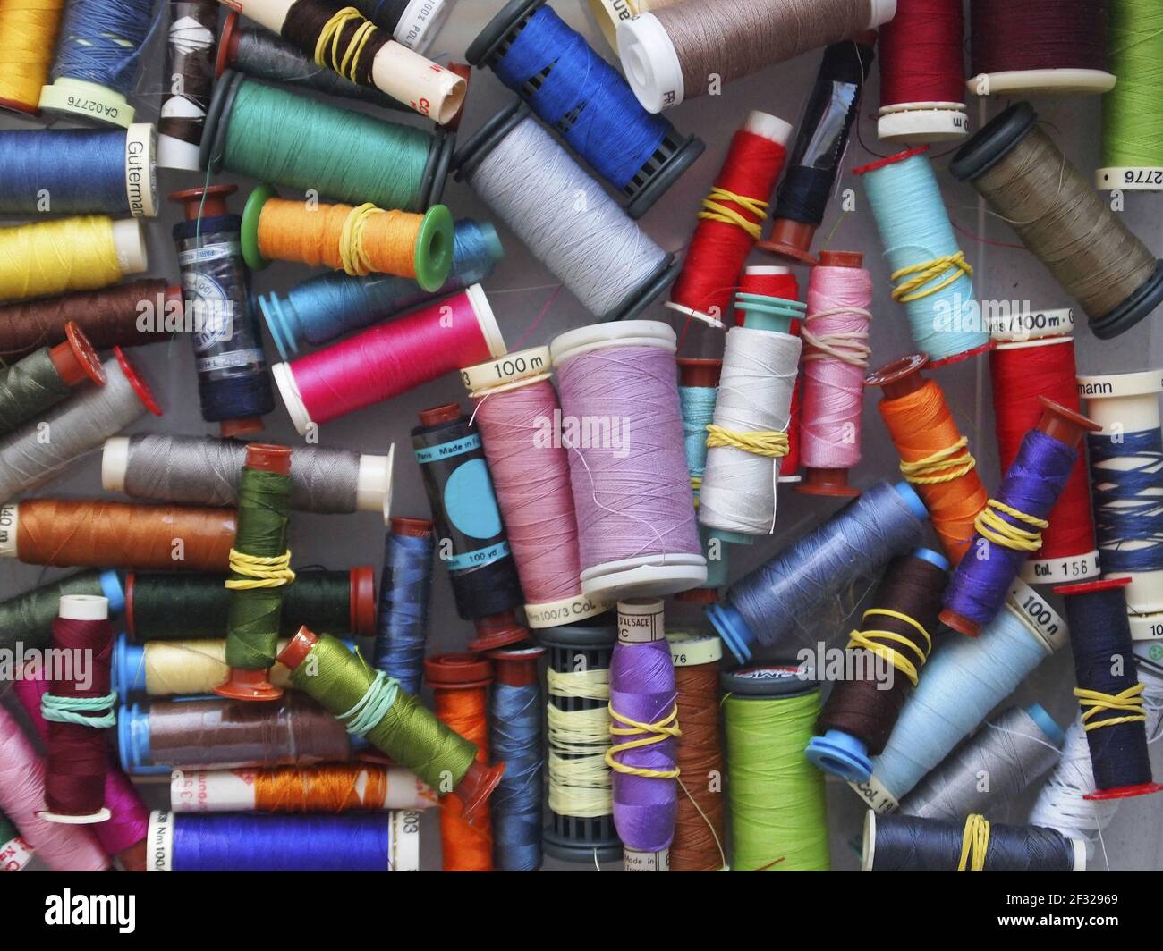 A top view of colorful sewing threads Stock Photo - Alamy