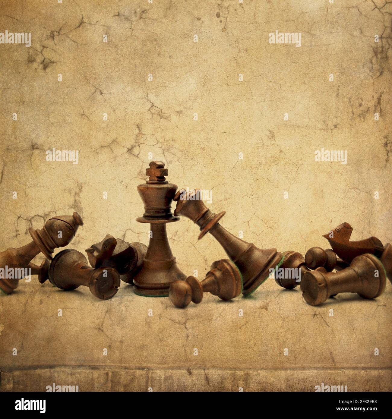 Tumbled chess set on a textured beige background Stock Photo - Alamy