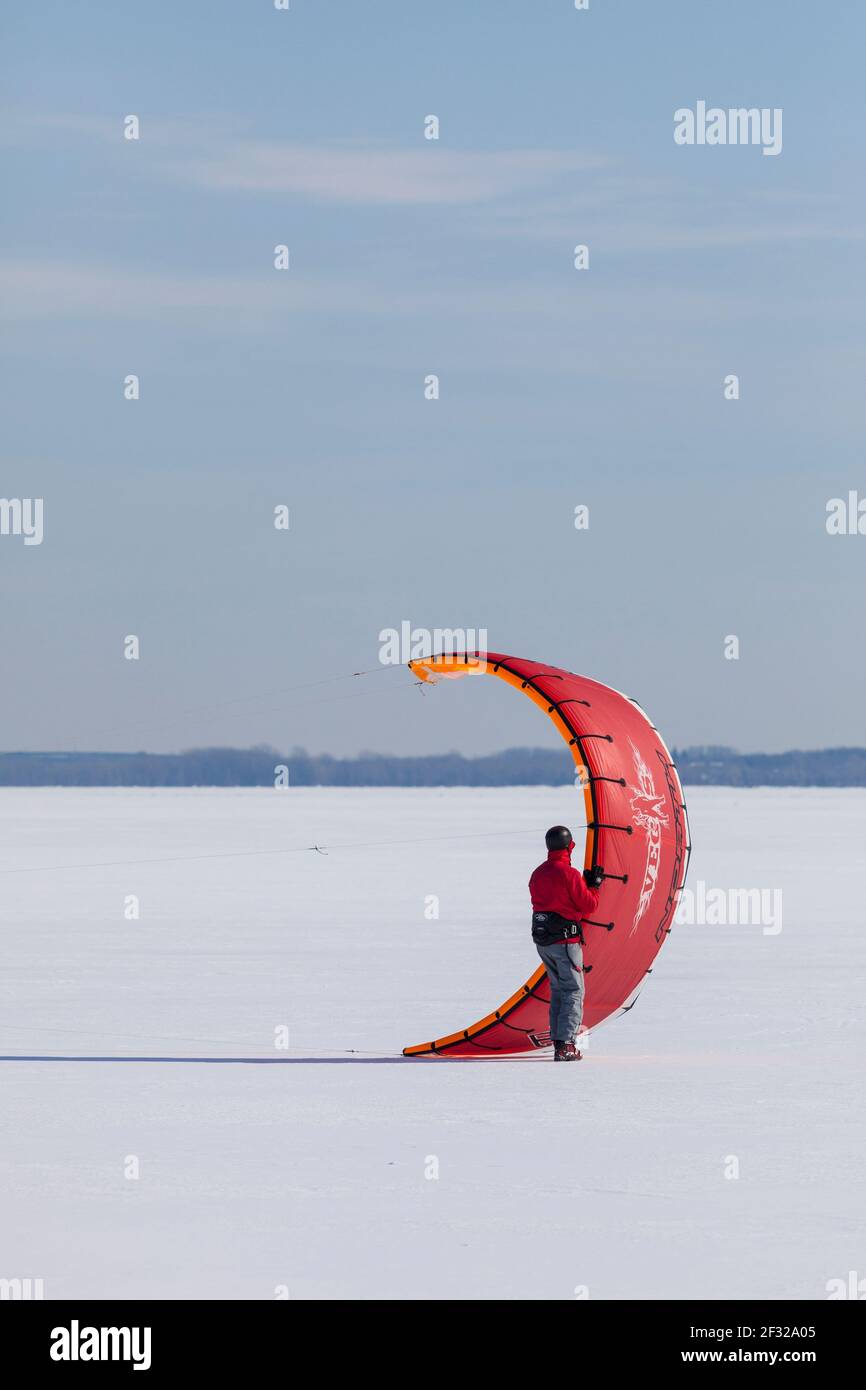 person preparing for kite skiing on Lake St. Louis, Winter frozen lake ...