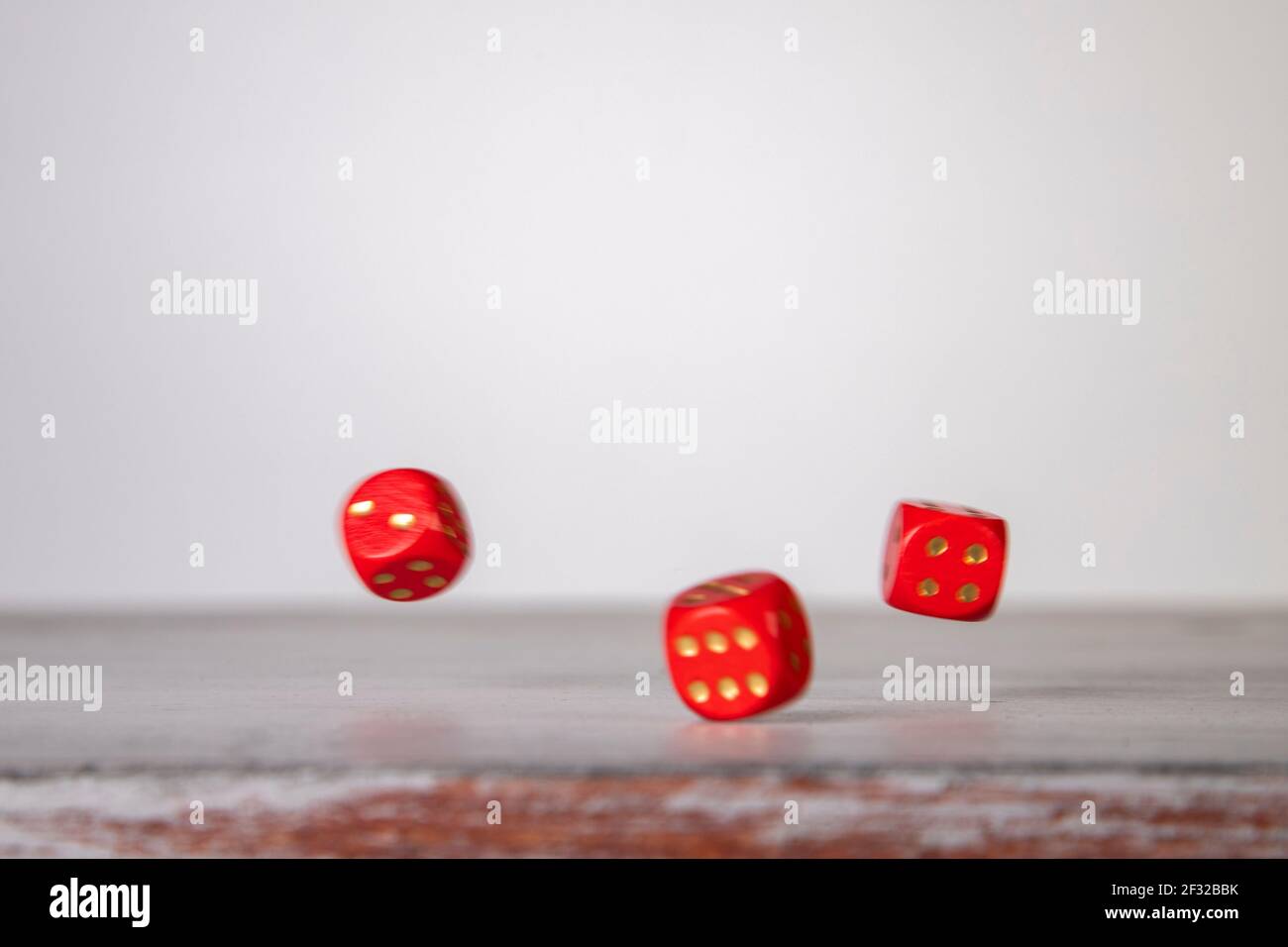 the die is cast, red dice falling on a gray wooden board Stock Photo ...