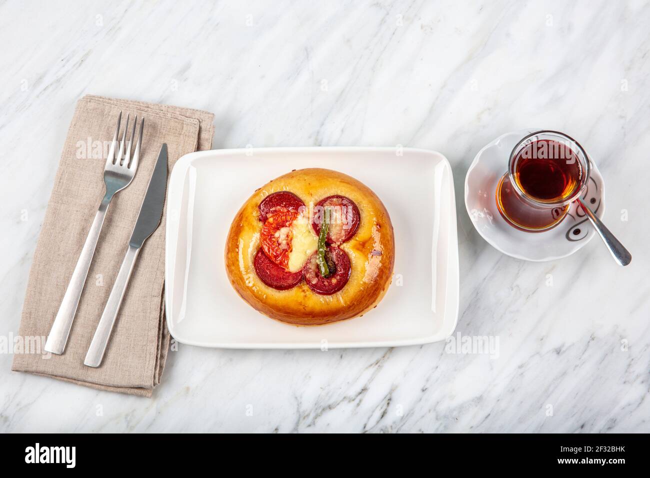 Turkish cuisine Sausage Mini Pizza. Puff pastry mini pizza with tomato ...
