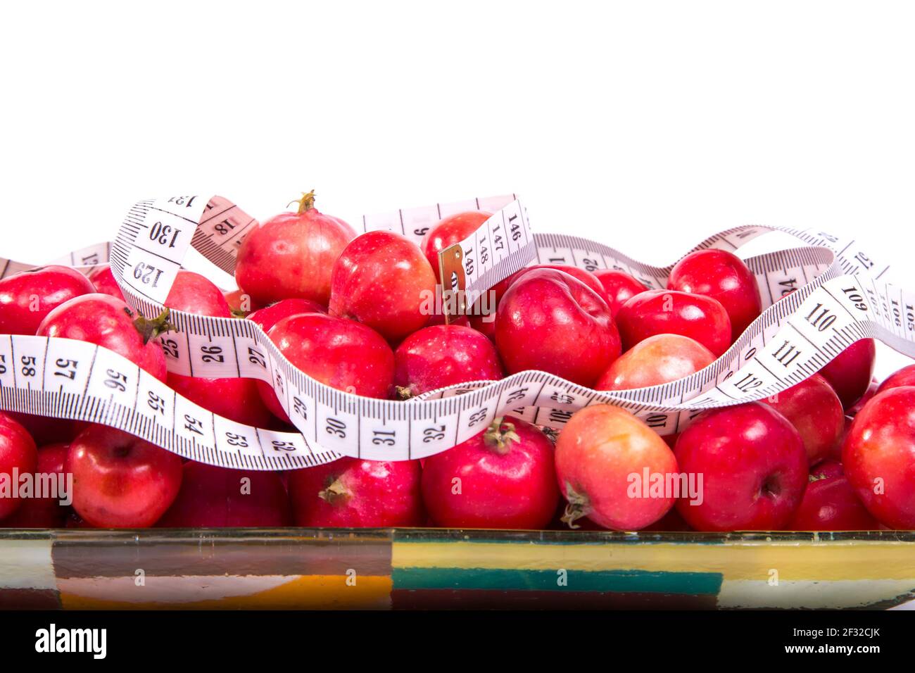 healthy food. Delicious apples with measuring tape on a white ...