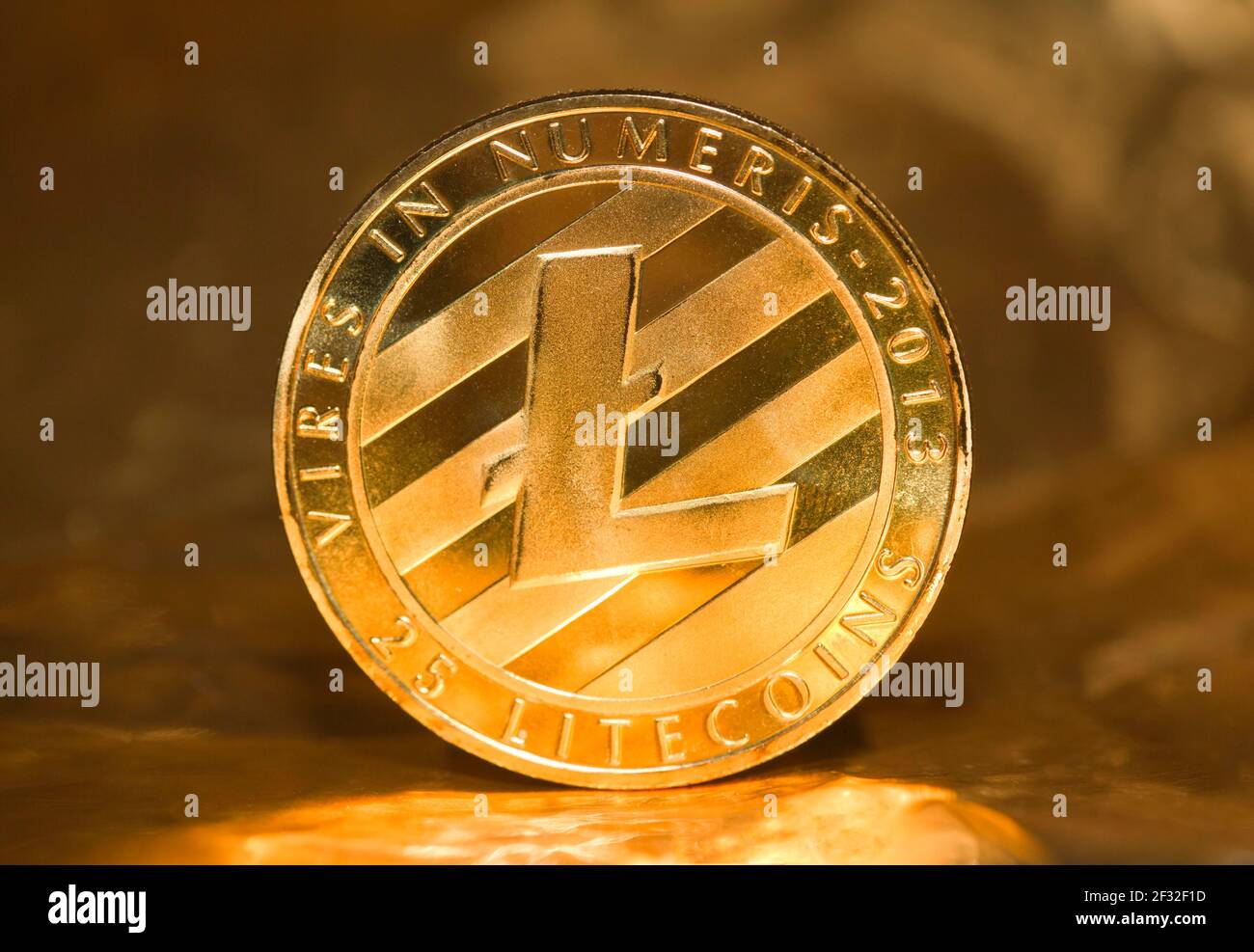 Litecoin, golden background Stock Photo - Alamy