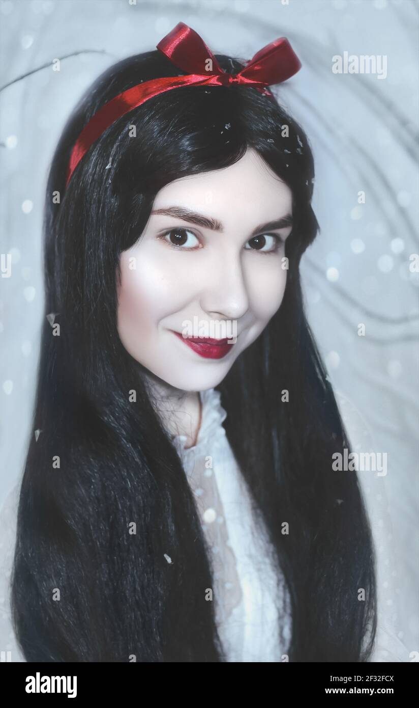 Young pretty woman with white skin and red lips is keeping the red ...