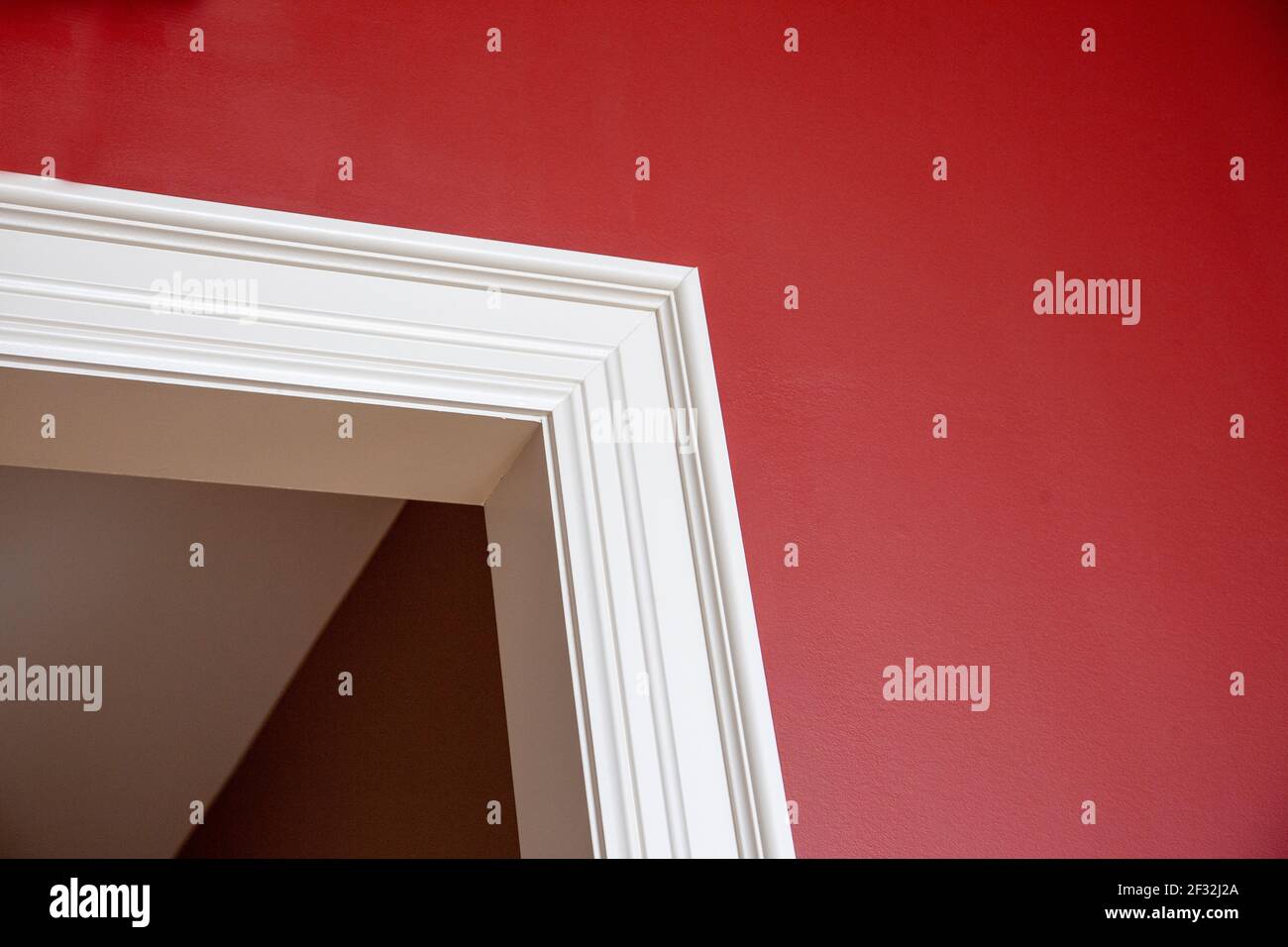 the white painted decorative corner of a door frame inside a home Stock ...