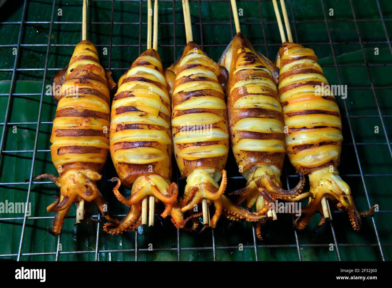Grilled squid skewers, Naka Weekend Market, Phuket, Thailand Stock Photo - Alamy