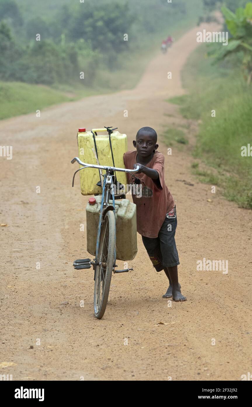 Boy pushing bicycle hi-res stock photography and images - Alamy
