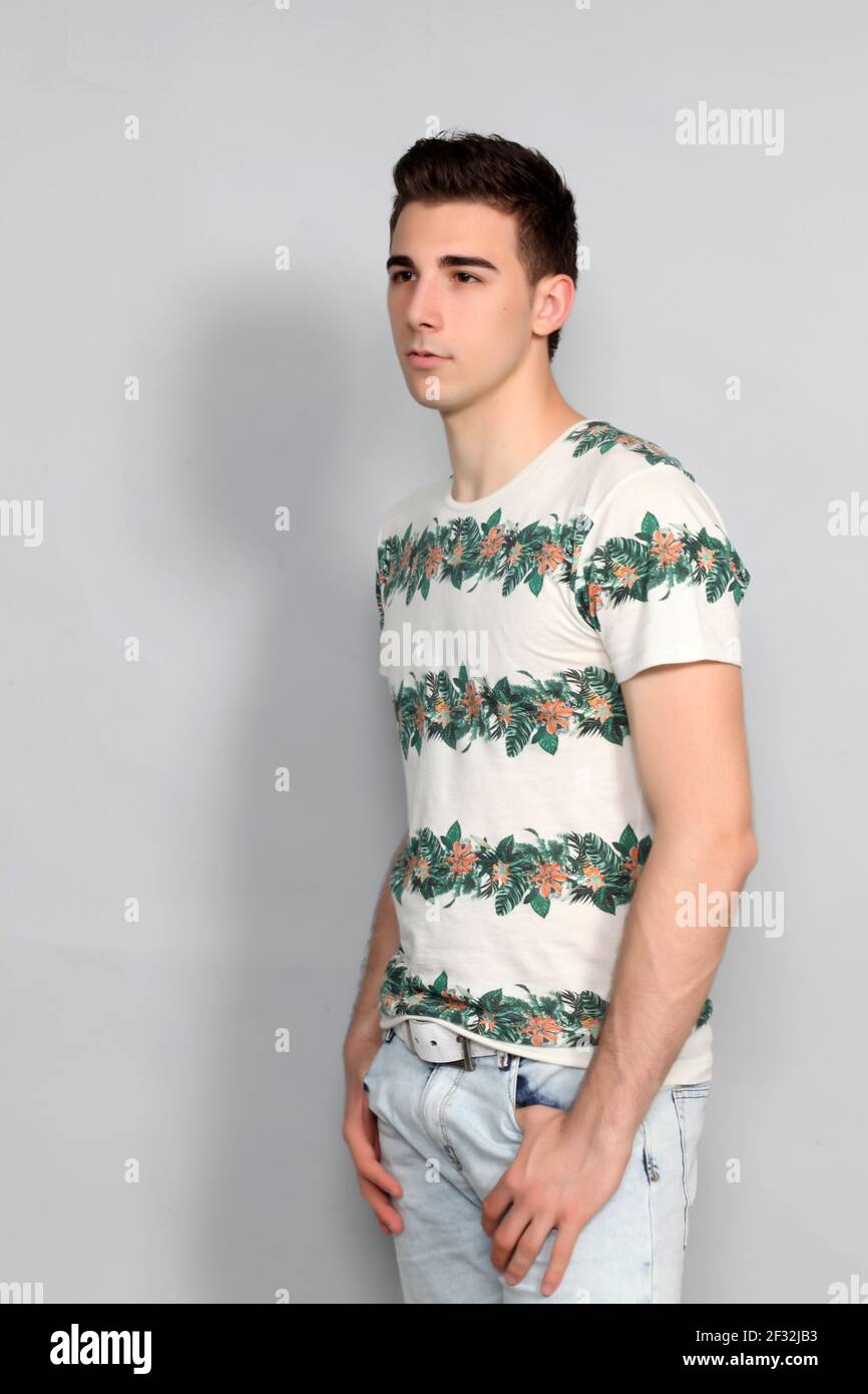 Attractive male model with short hair posing in studio on isolated ...