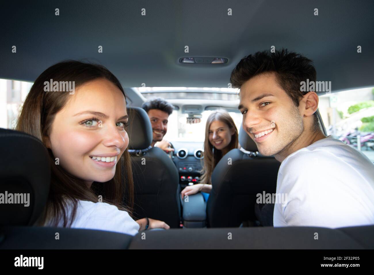 Group of happy friends on a car Stock Photo - Alamy