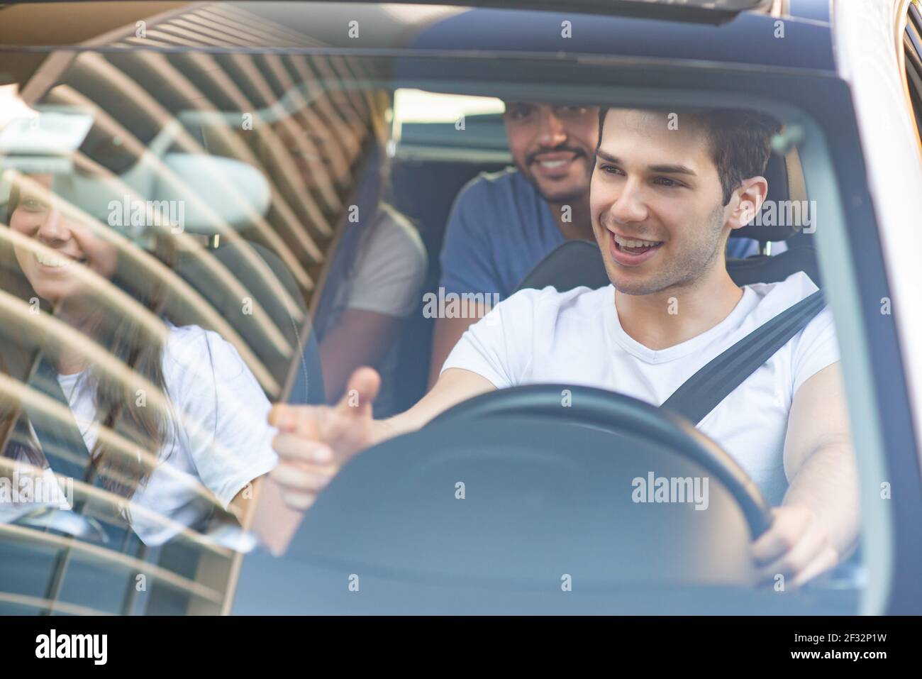 Group of happy friends sharing the same car for a trip Stock Photo - Alamy
