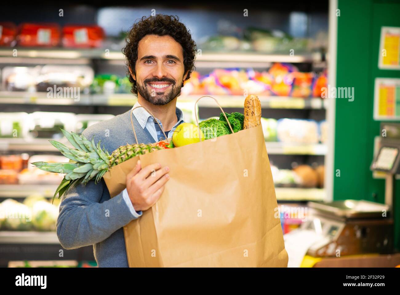 Man holding an healthy food bag in a Grocery store Stock Photo - Alamy