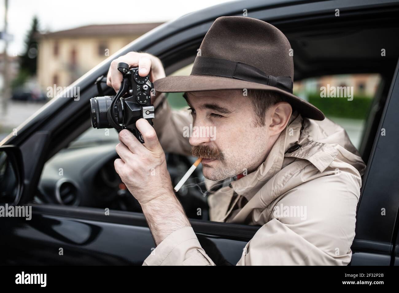 Spy or paparazzo photographer, detective using camera in his car Stock ...