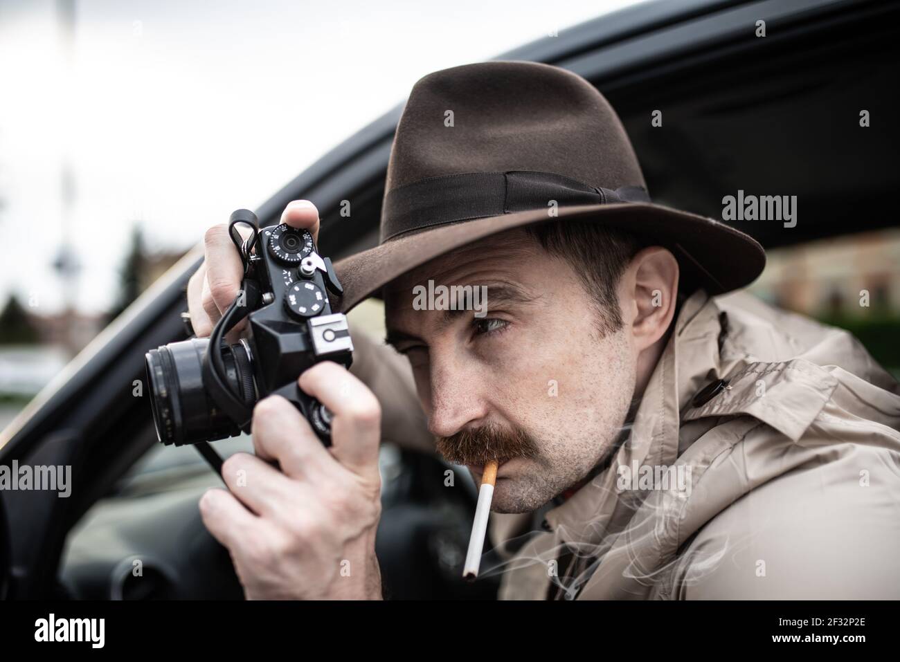 Spy or paparazzo photographer, detective using camera in his car Stock ...