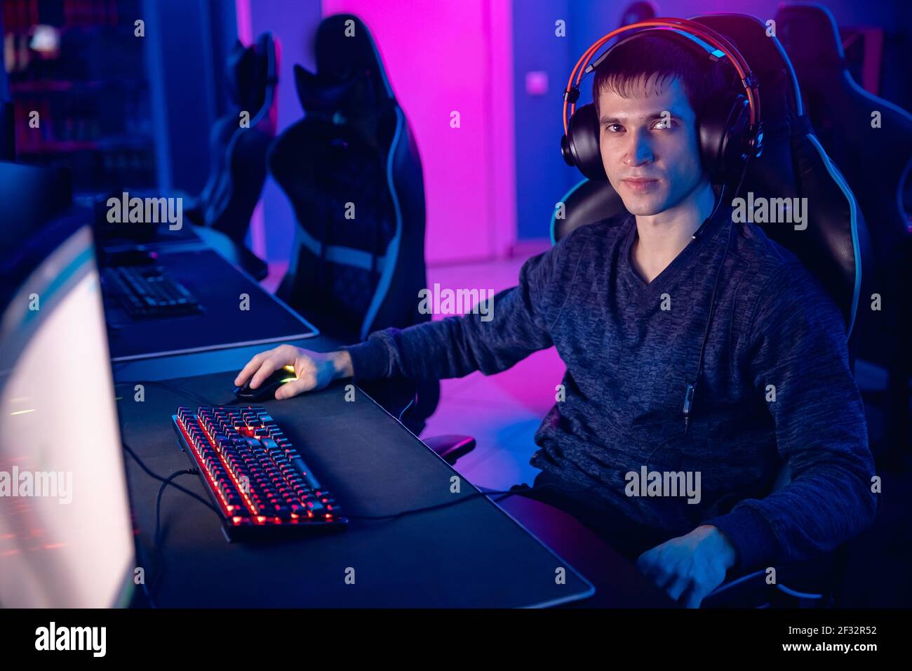 Portrait young man professional gamer playing online games computer ...