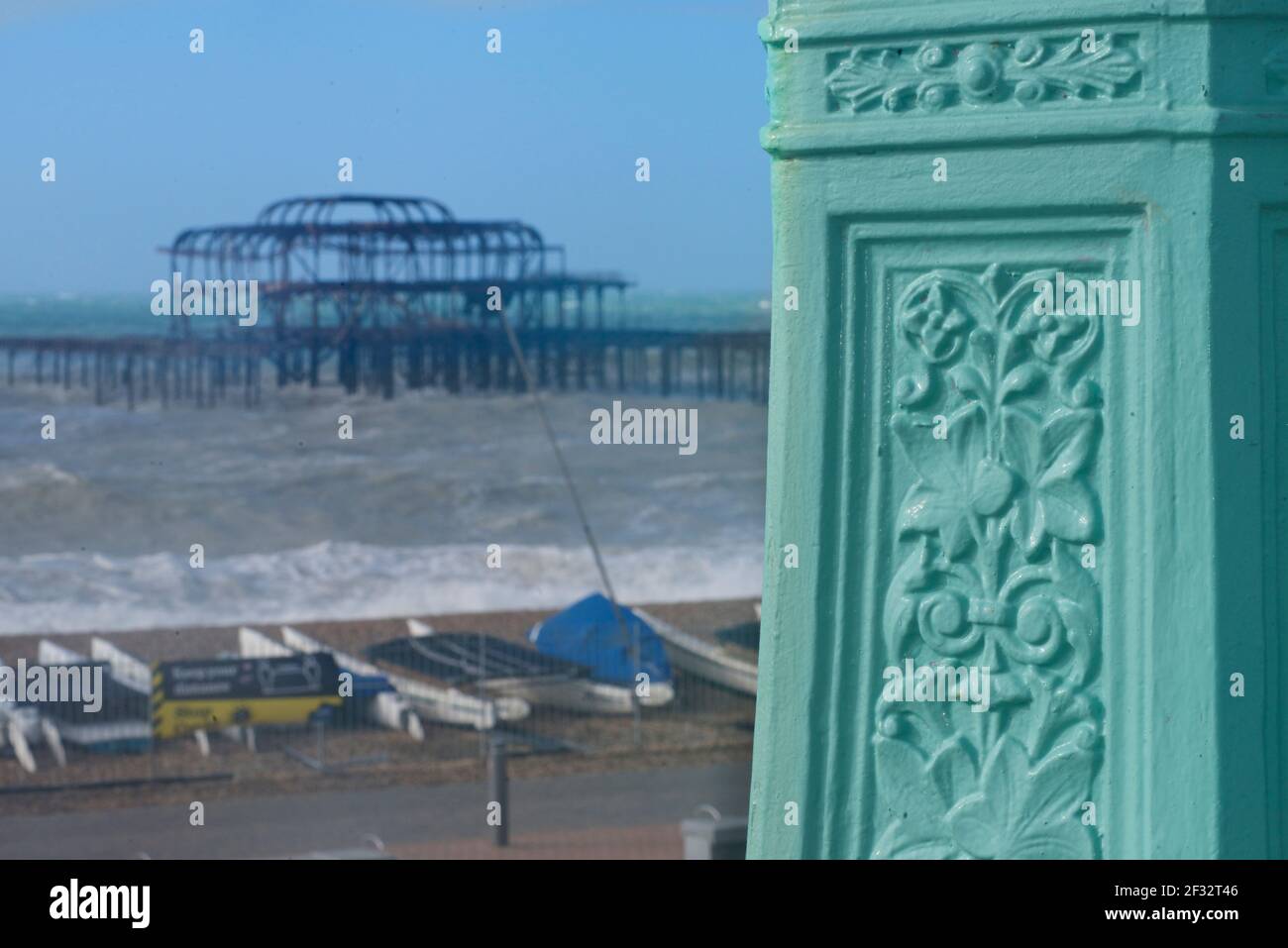 Detail of apainted Victorian cast iron lamp post with the ruins of the ...
