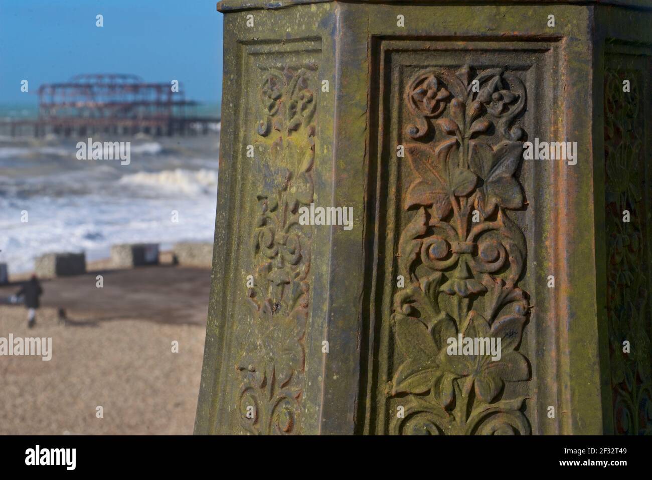 Detail of an unpainted Victorian cast iron lamp post with the ruins of ...