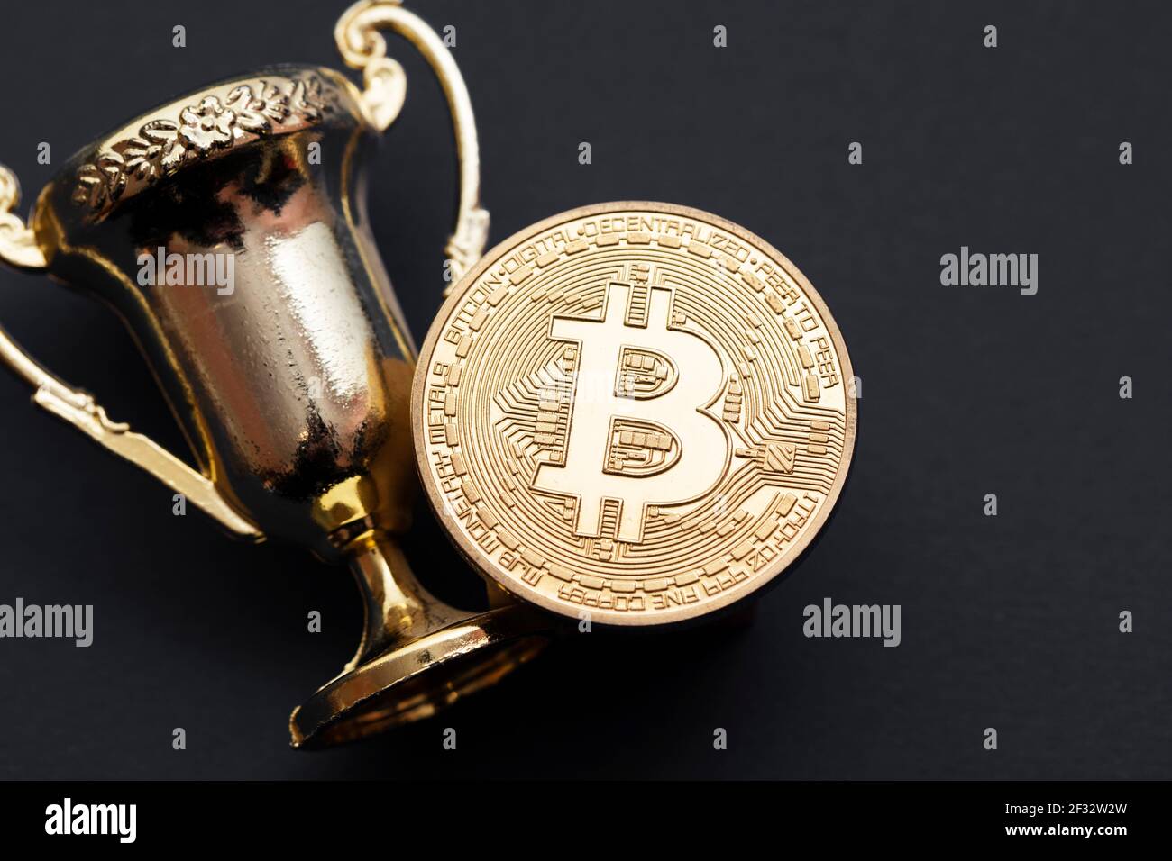 Gold bitcoin cryptocurrency coin with a winning golden trophy Stock ...
