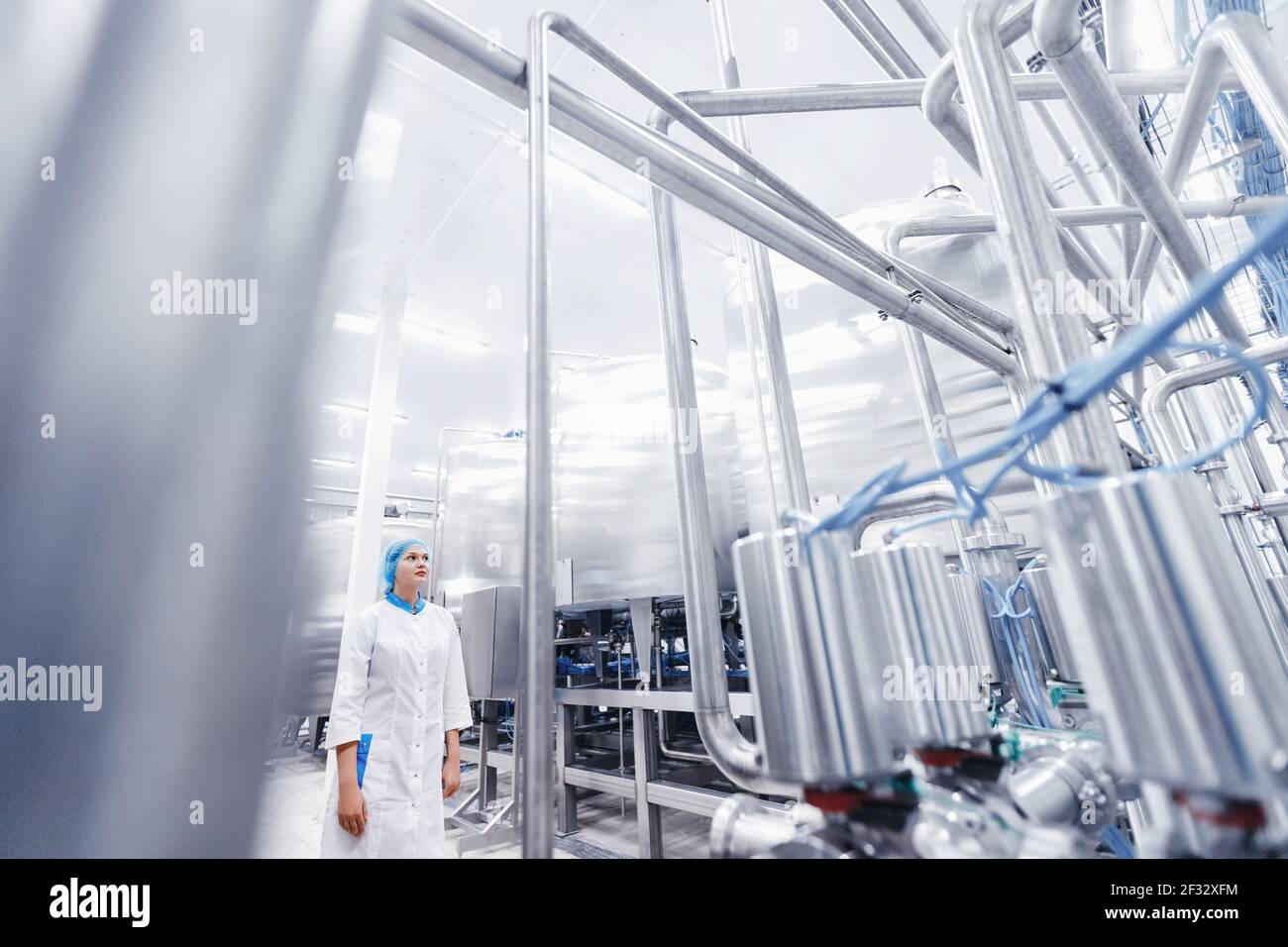 Industrial portrait operator female in uniform background food factory ...