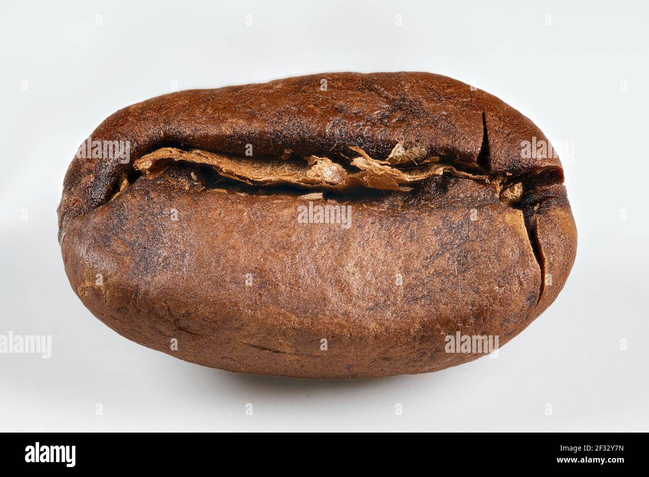 Extreme close up macro photograph of a coffee bean isolated against a ...