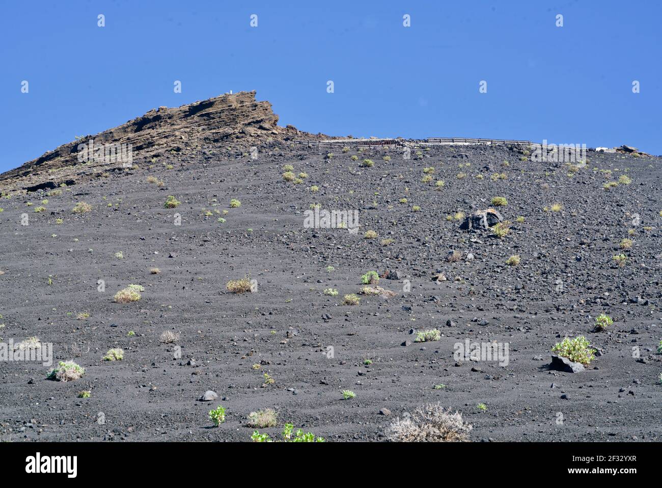 Black lava of a volcano under a perfect blue sky Stock Photo - Alamy