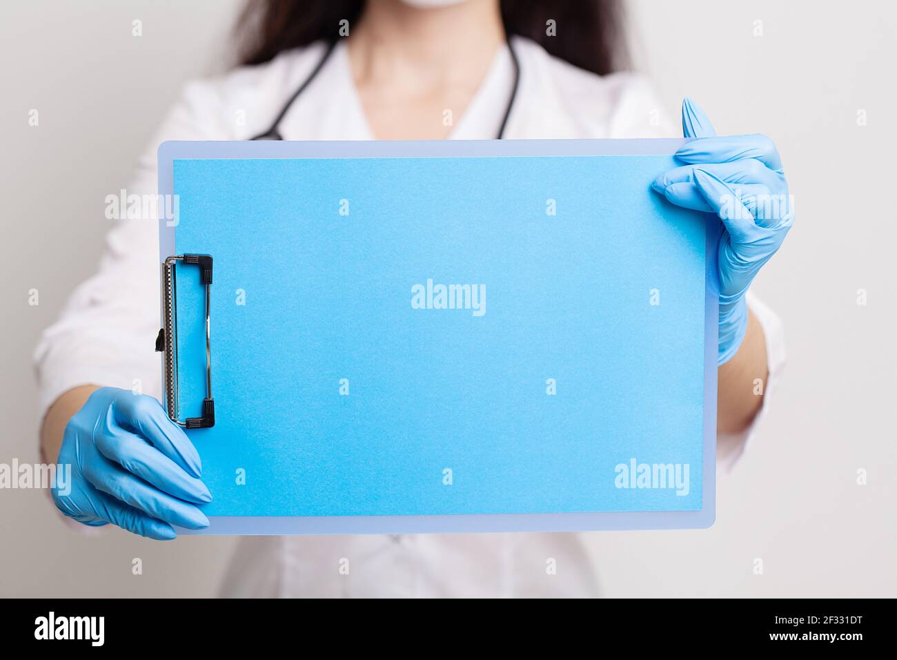 Female doctor holding a blank sheet of paper with space for text Stock ...