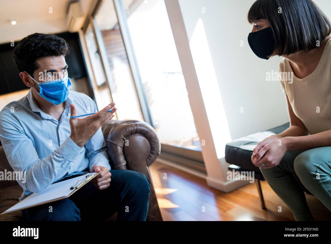 Psychologist talking with patient on therapy session Stock Photo - Alamy