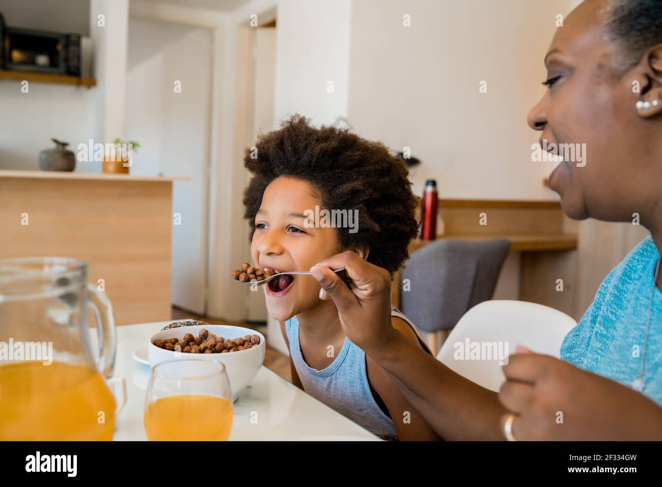 Grandmother and grandchild having breakfast together Stock Photo - Alamy