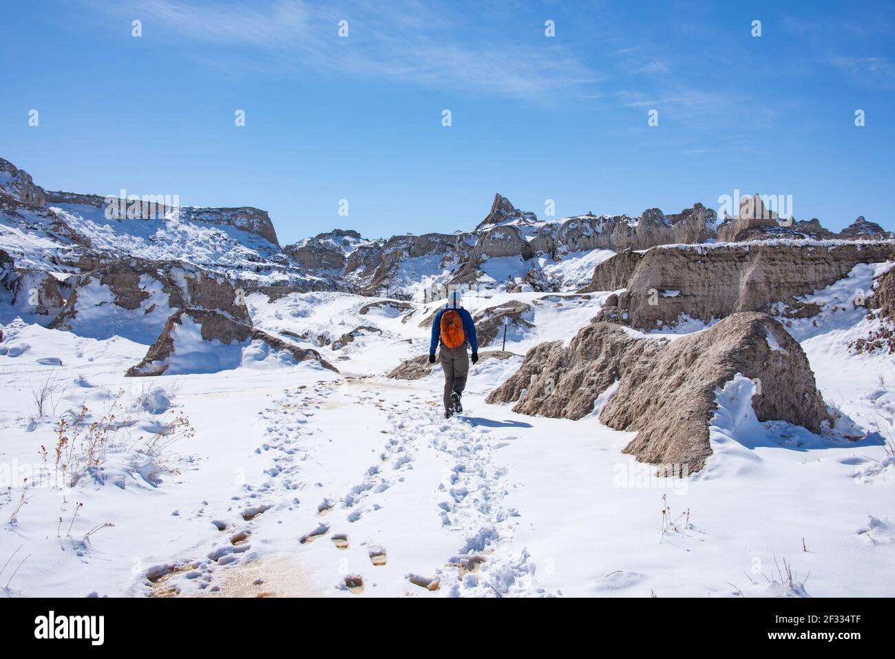 Trekking in Badlands National Park in winter, South Dakota, U. S. A ...