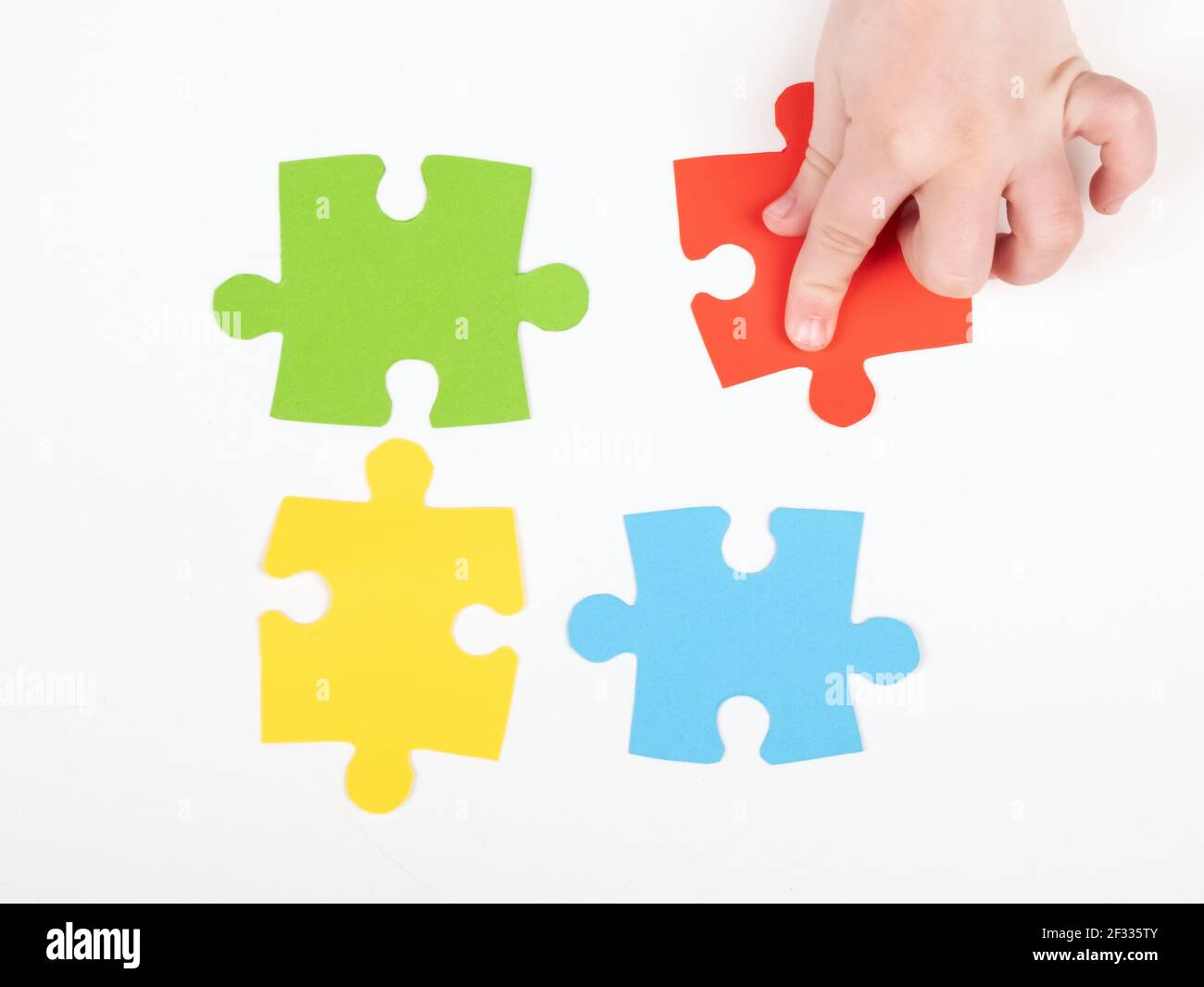 a child with autism collects puzzles,teaching children Stock Photo - Alamy