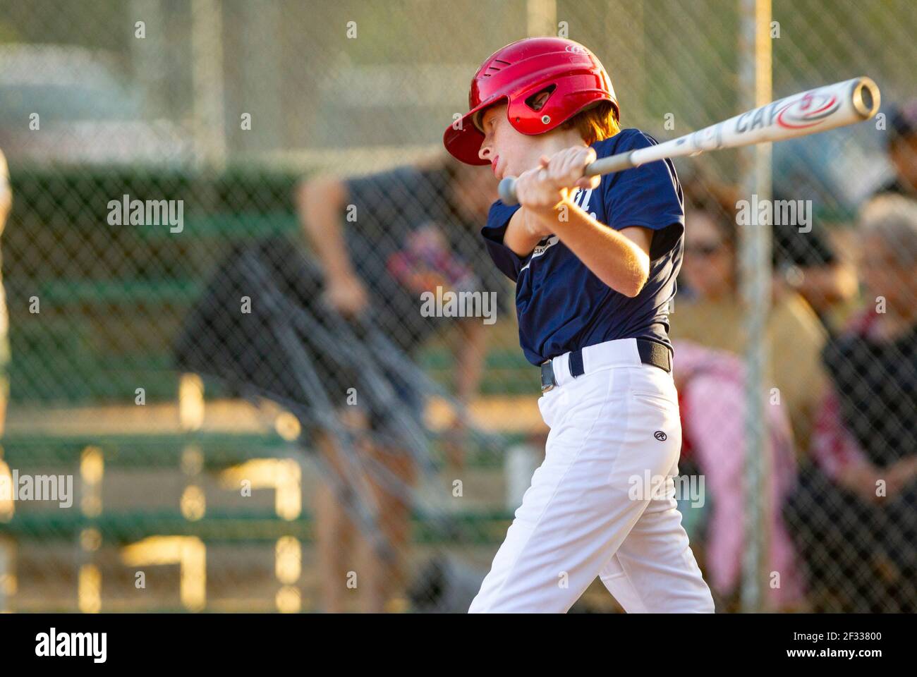 A red-headed teenage boy batting during a baseball game Stock Photo - Alamy