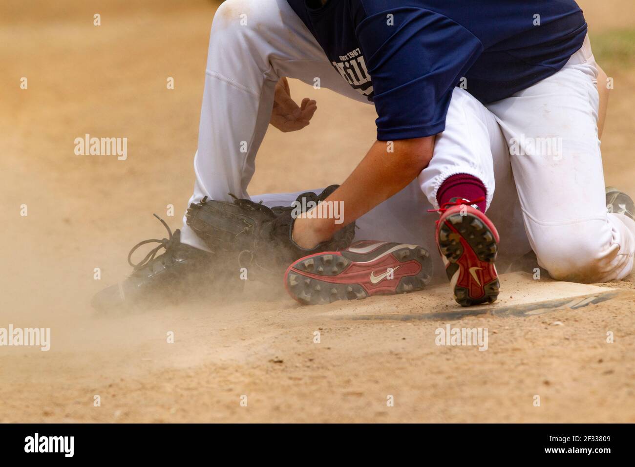 The pitcher tags out a player trying to score a run at home plate Stock ...