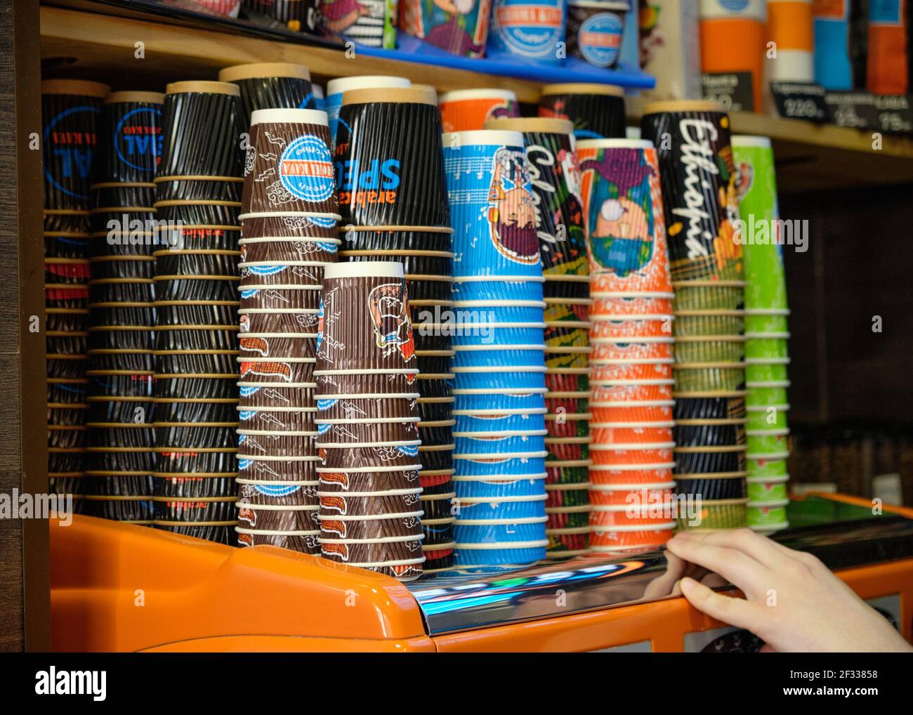 Disposable branded coffee cup, on top of coffee machine, in Cafe Aroma ...