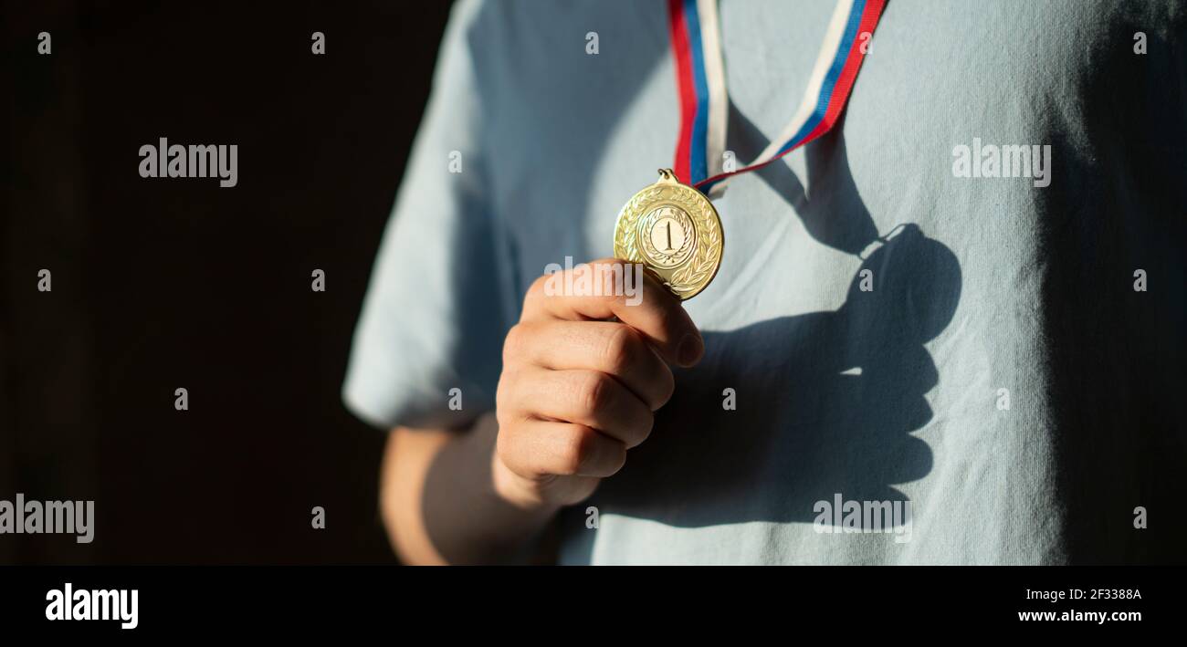 male sportsman with a golden medal on a chest, champion leader Stock ...