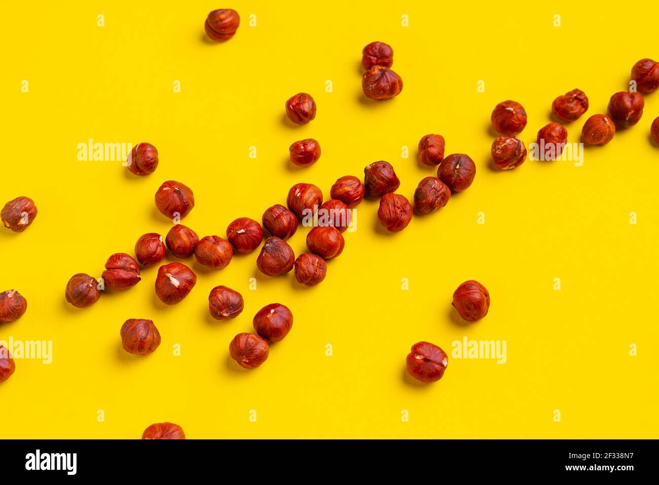 a dropped bunch of hazelnut nut without shell flat lay, minimalistic ...