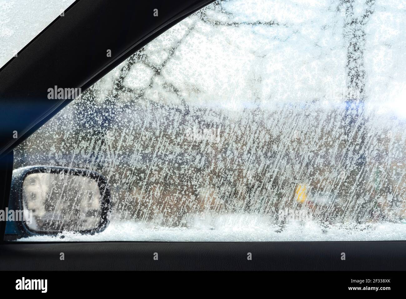 a car window glass under the frozen ice, cold winter problems concept ...