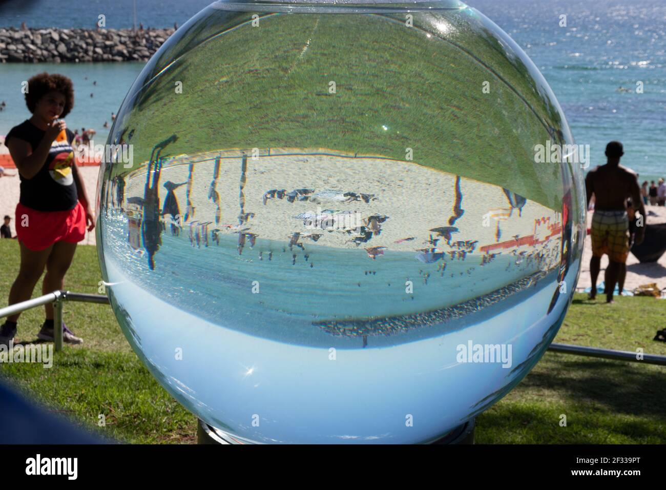 View Through Glass Ball Sculpture of Inverted Beach Scene Stock Photo ...